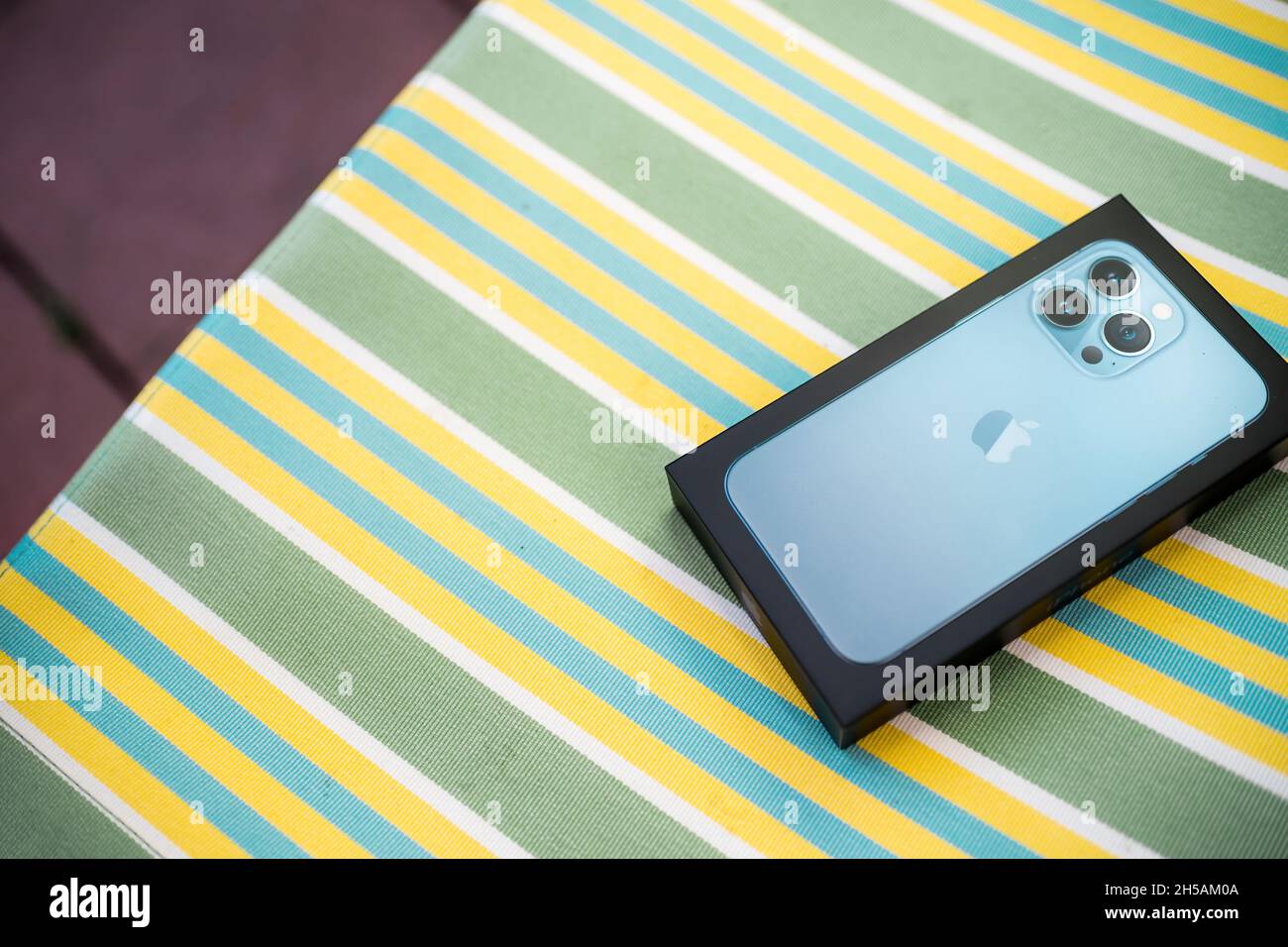 Close-up of terrace branch chair with new cardboard package of iPhone ...