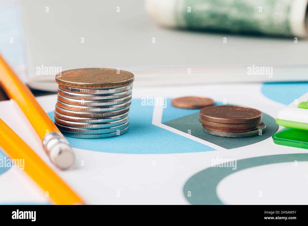 pile of money coins with graph paper on wood table, concept in account ...