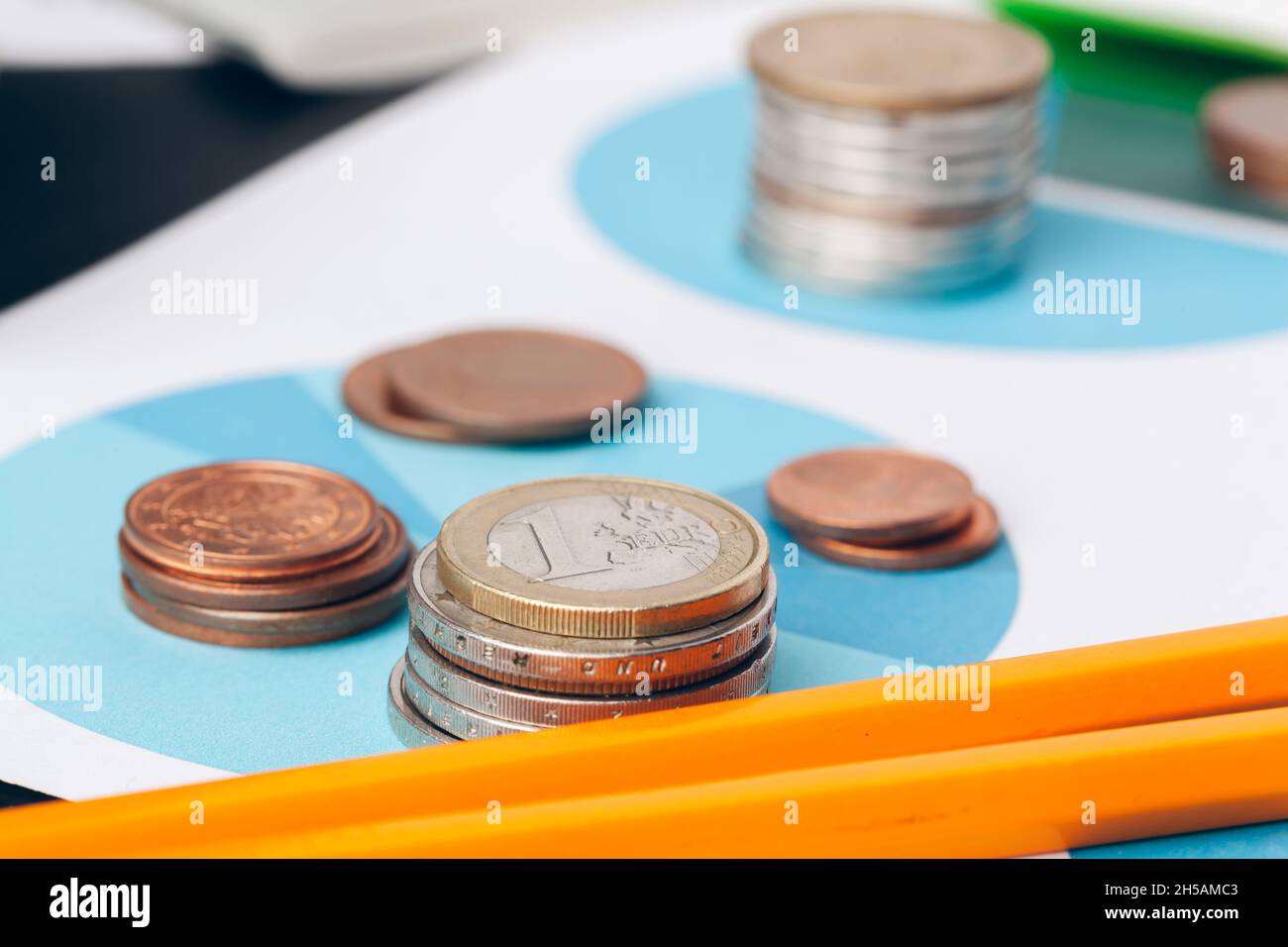 pile of money coins with graph paper on wood table, concept in account ...
