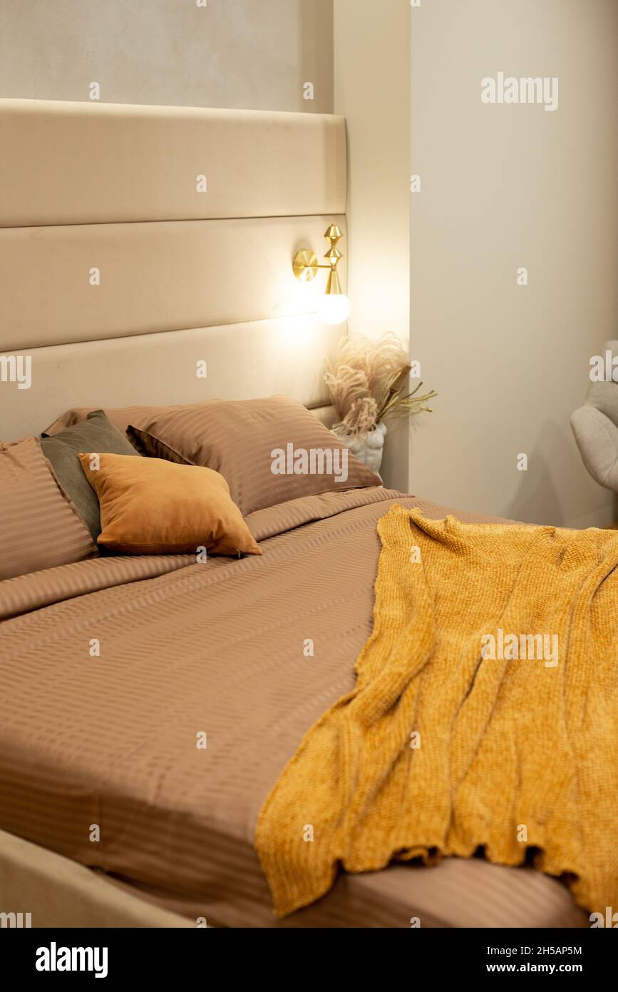 Modern bedroom in beige colors, interior design. Soft selective focus ...