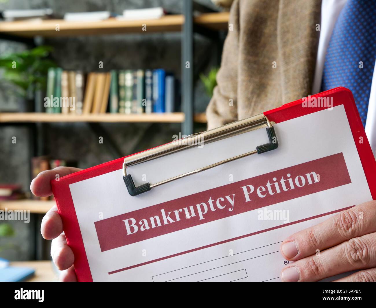Manager proposes bankruptcy petition form for signing Stock Photo - Alamy