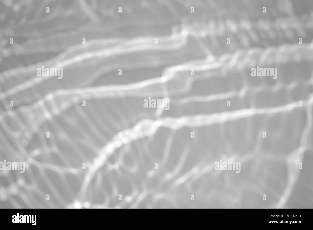 blurred shadow and light caustic effect on a white wall Stock Photo - Alamy