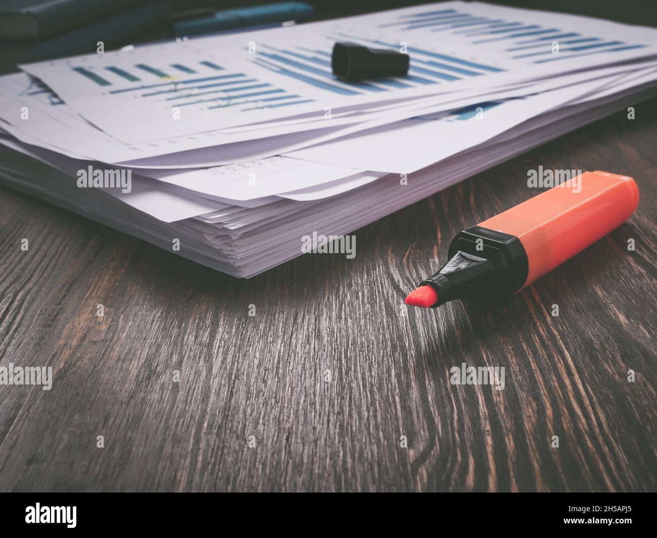 Stack of papers with financial report and taxes for audit and marker ...