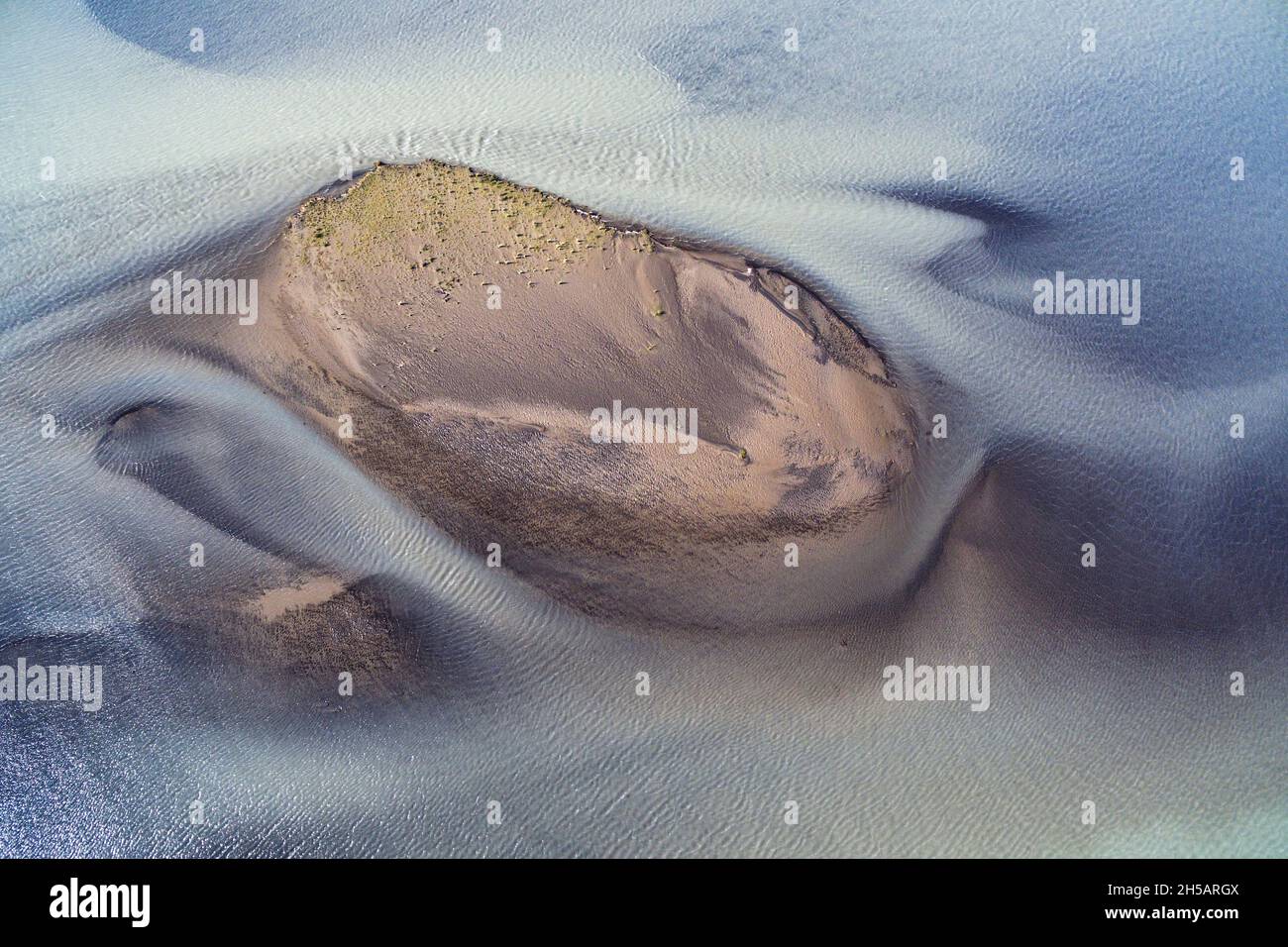 Aerial view of small island in shallow water in the glacial river ...