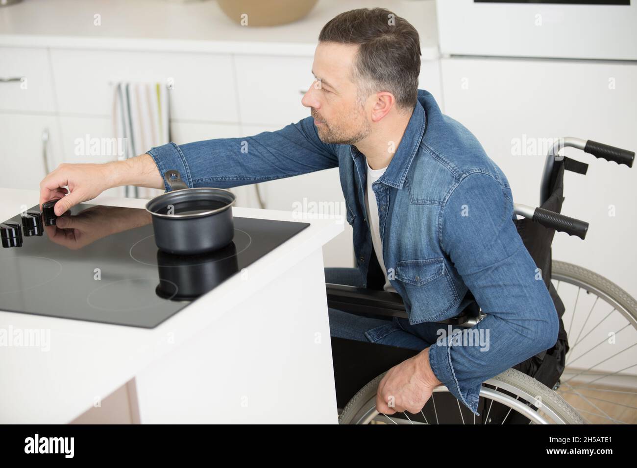 happy disabled man cooking pasta Stock Photo - Alamy