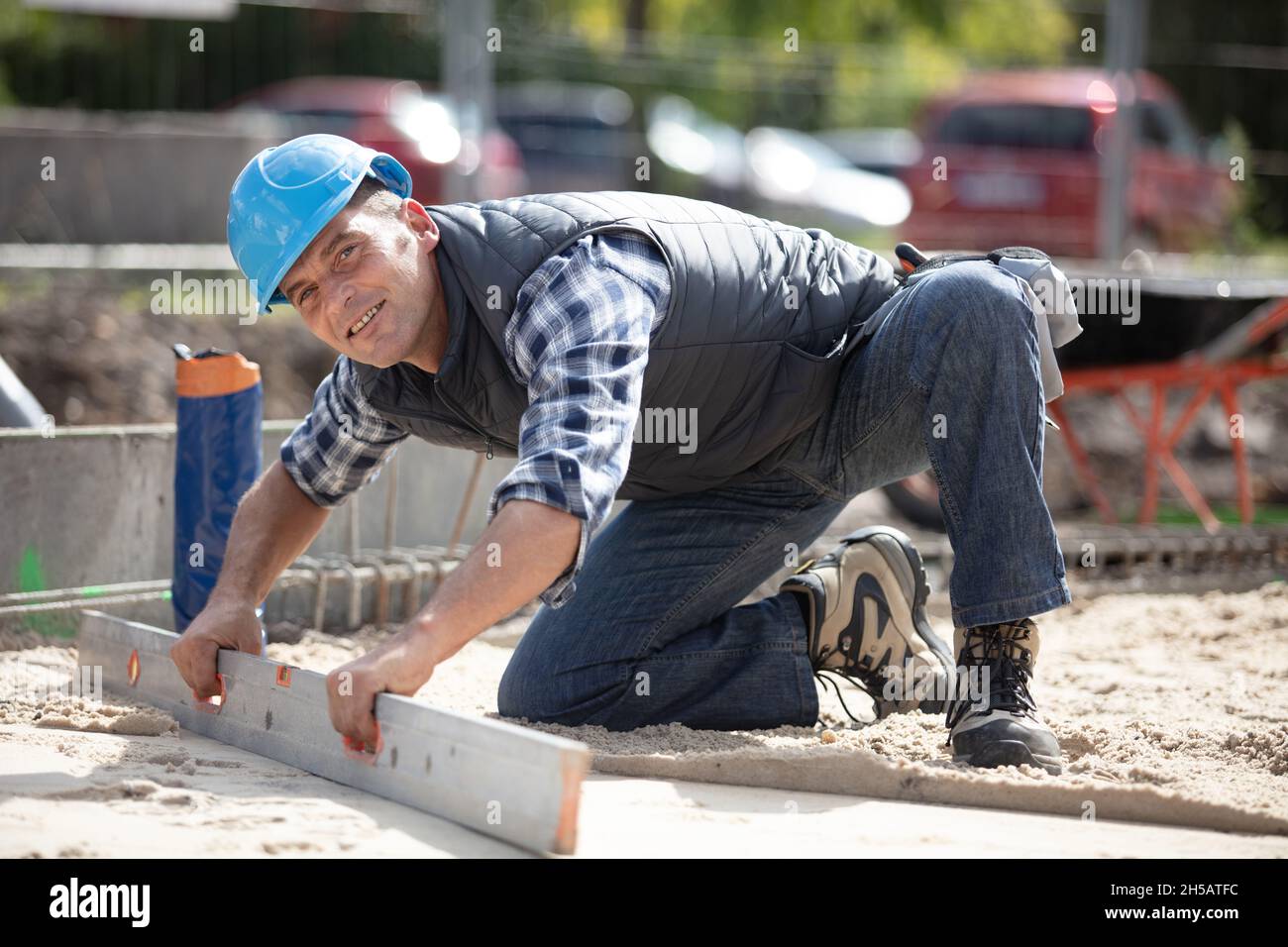 Construction workers installing leveling system hi-res stock ...