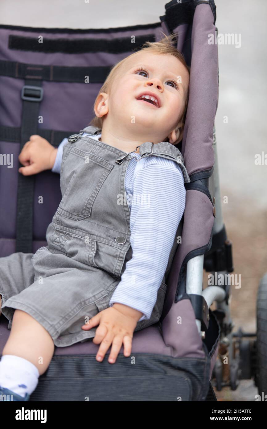 adorable baby boy wearing in a stroller Stock Photo - Alamy
