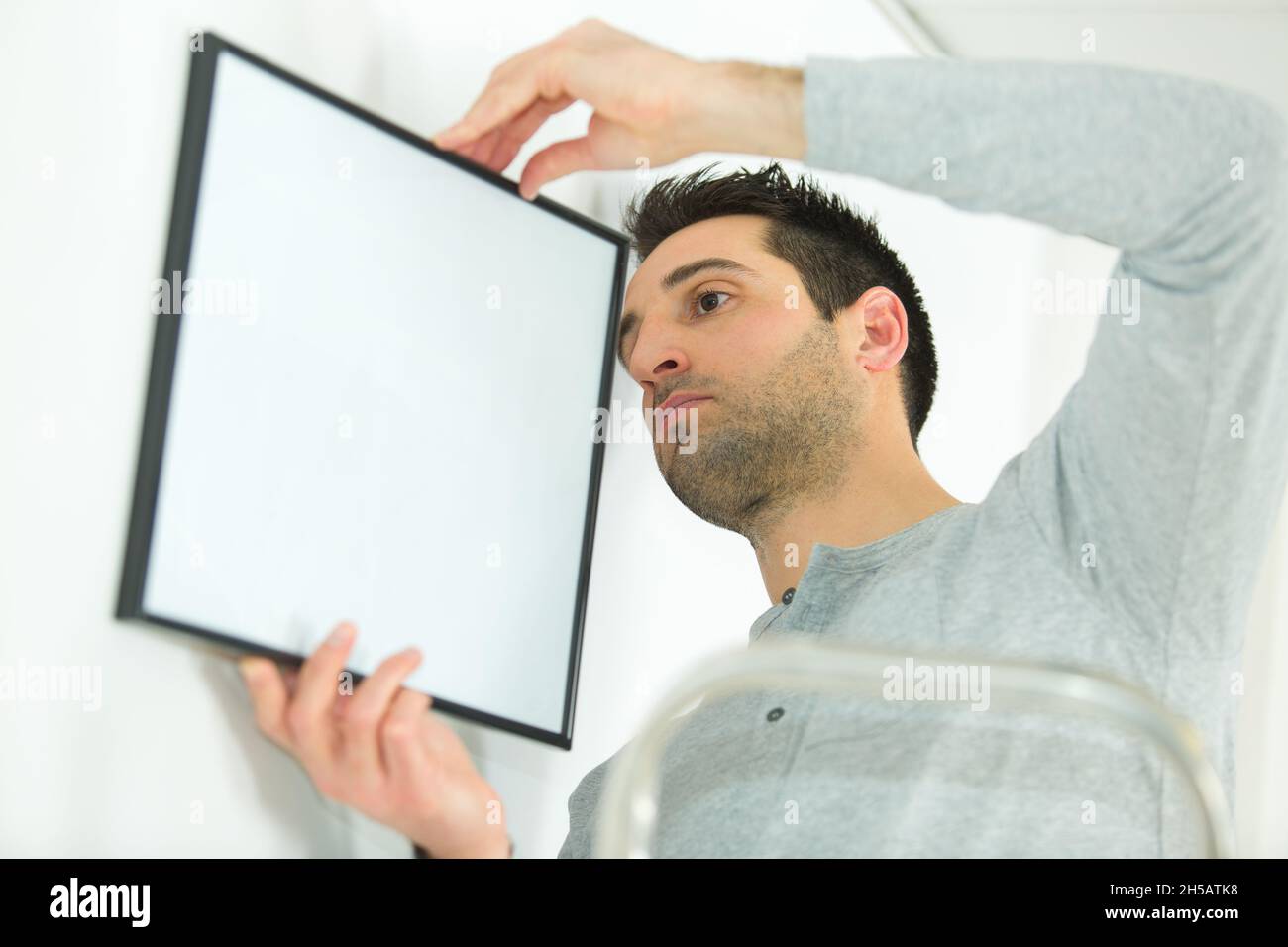 Putting up picture hi-res stock photography and images - Alamy