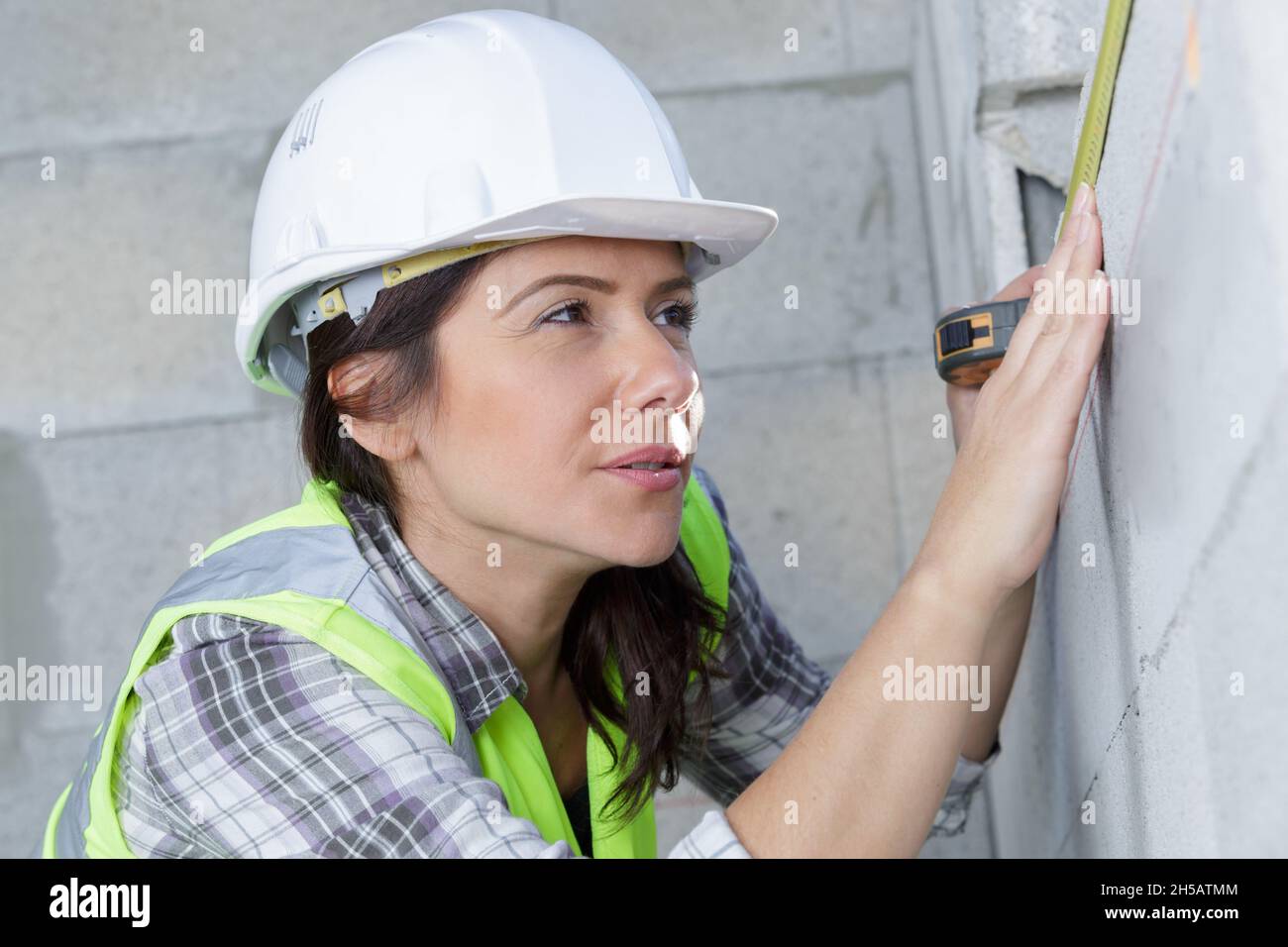 a woman is building a wall Stock Photo - Alamy