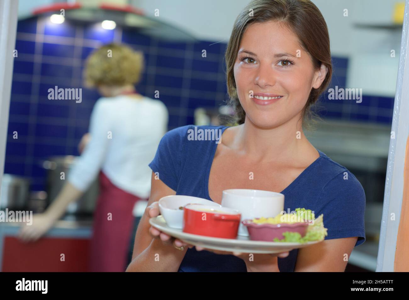 portrait of happy waitress serving in restaurant Stock Photo - Alamy
