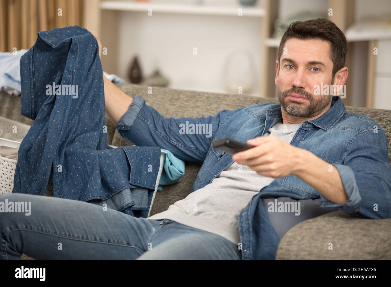 bored man watching tv at home Stock Photo - Alamy