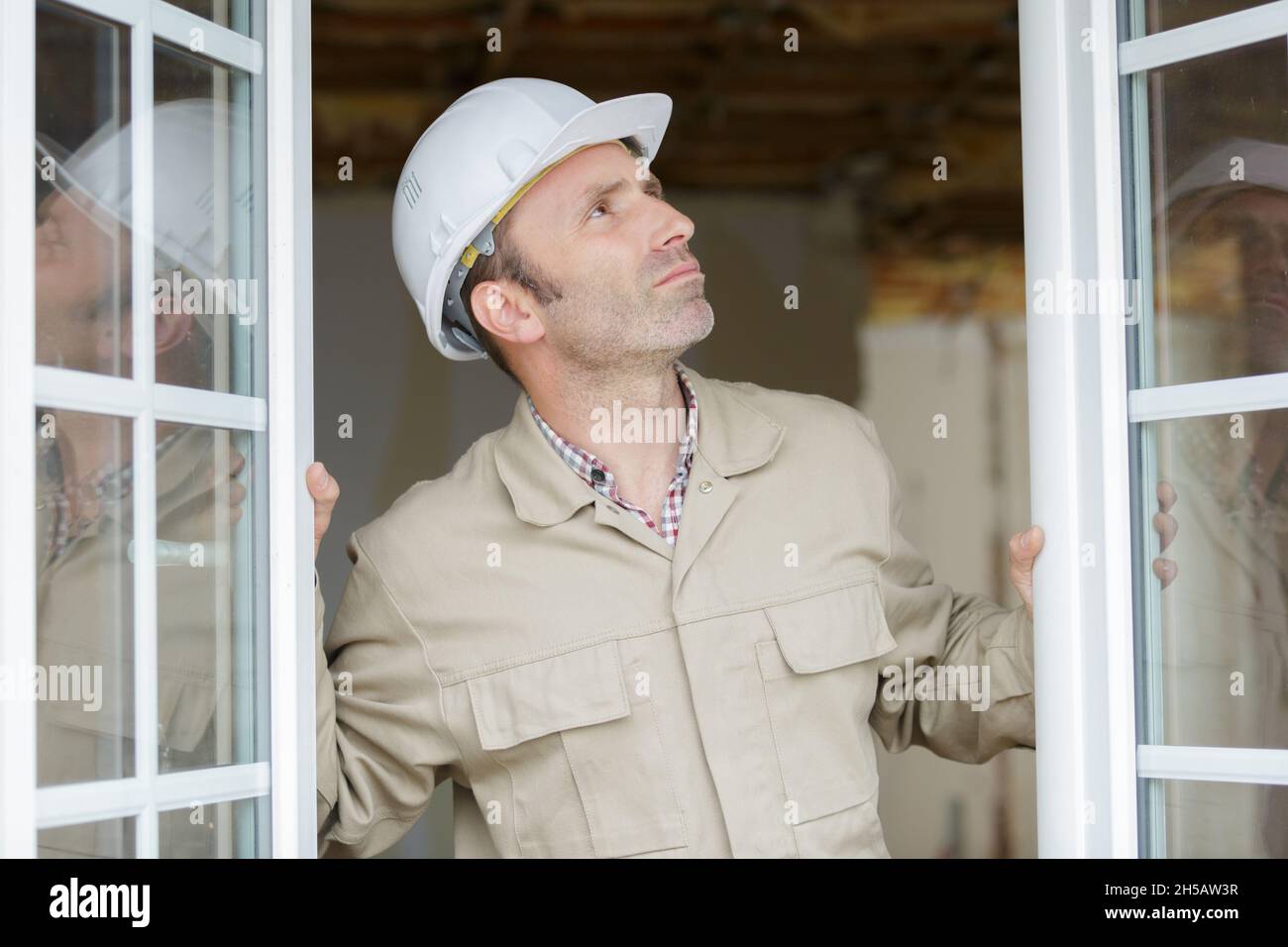 close up of a man installing a window Stock Photo - Alamy