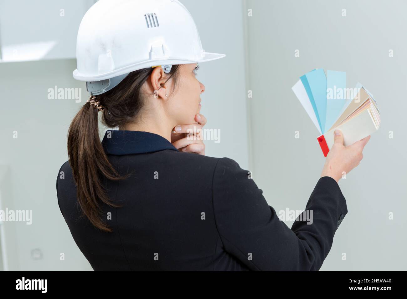 female architect picking the right color for the wall Stock Photo - Alamy