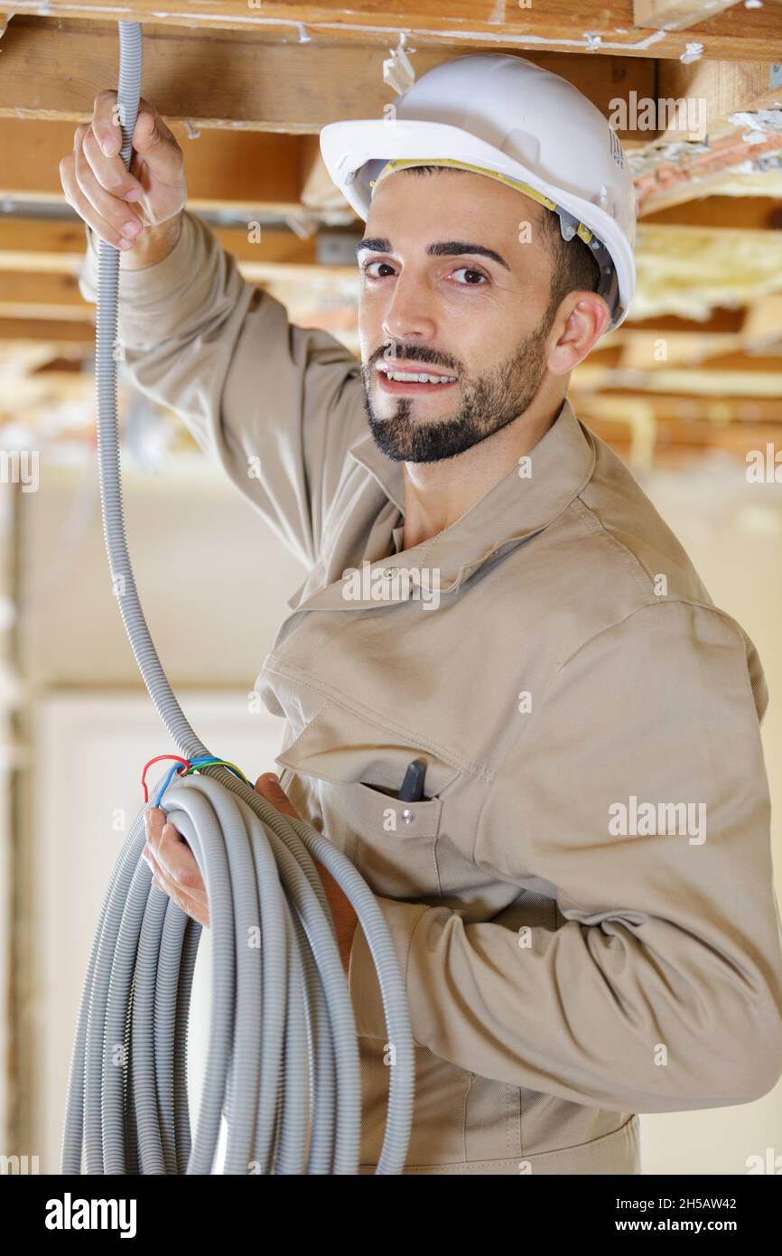 electrical worker wiring in ceiling Stock Photo - Alamy