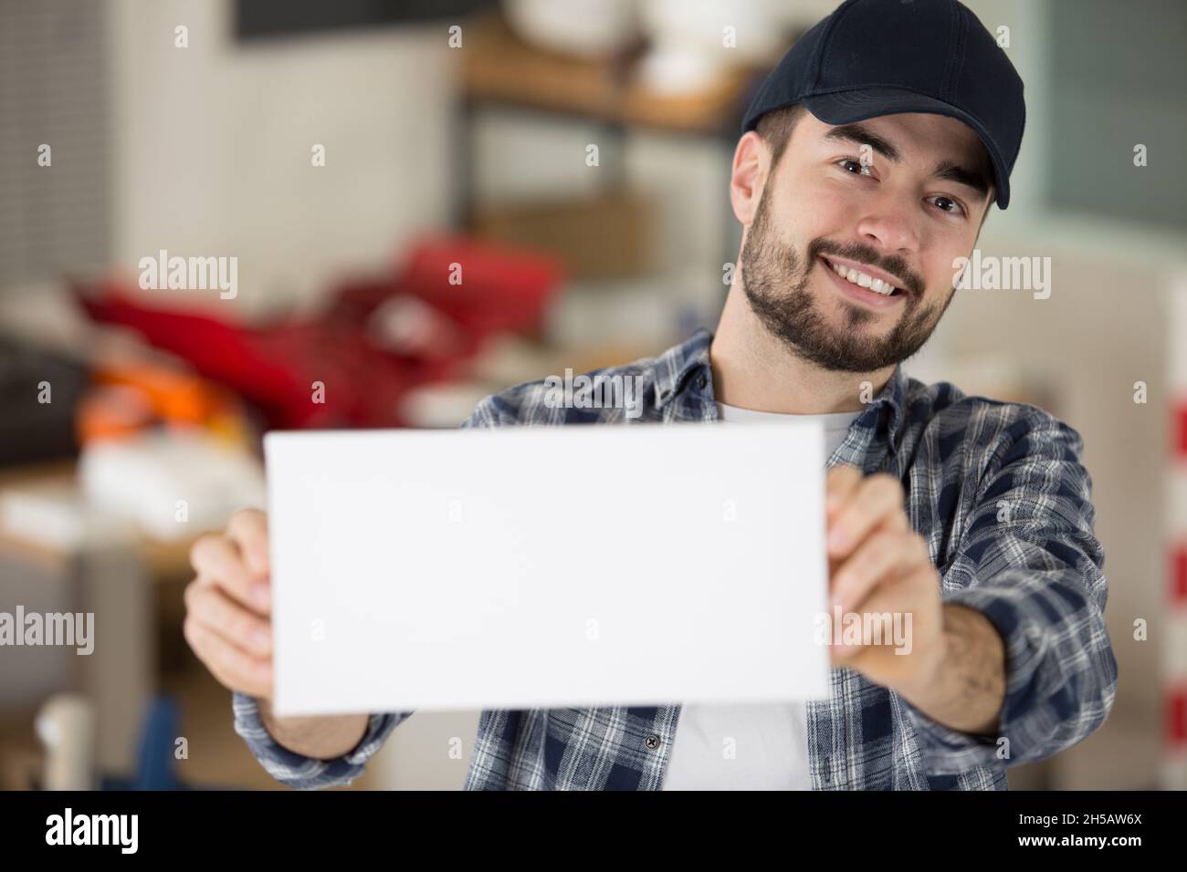 happy male engineer holding an advertisement blank banner Stock Photo ...
