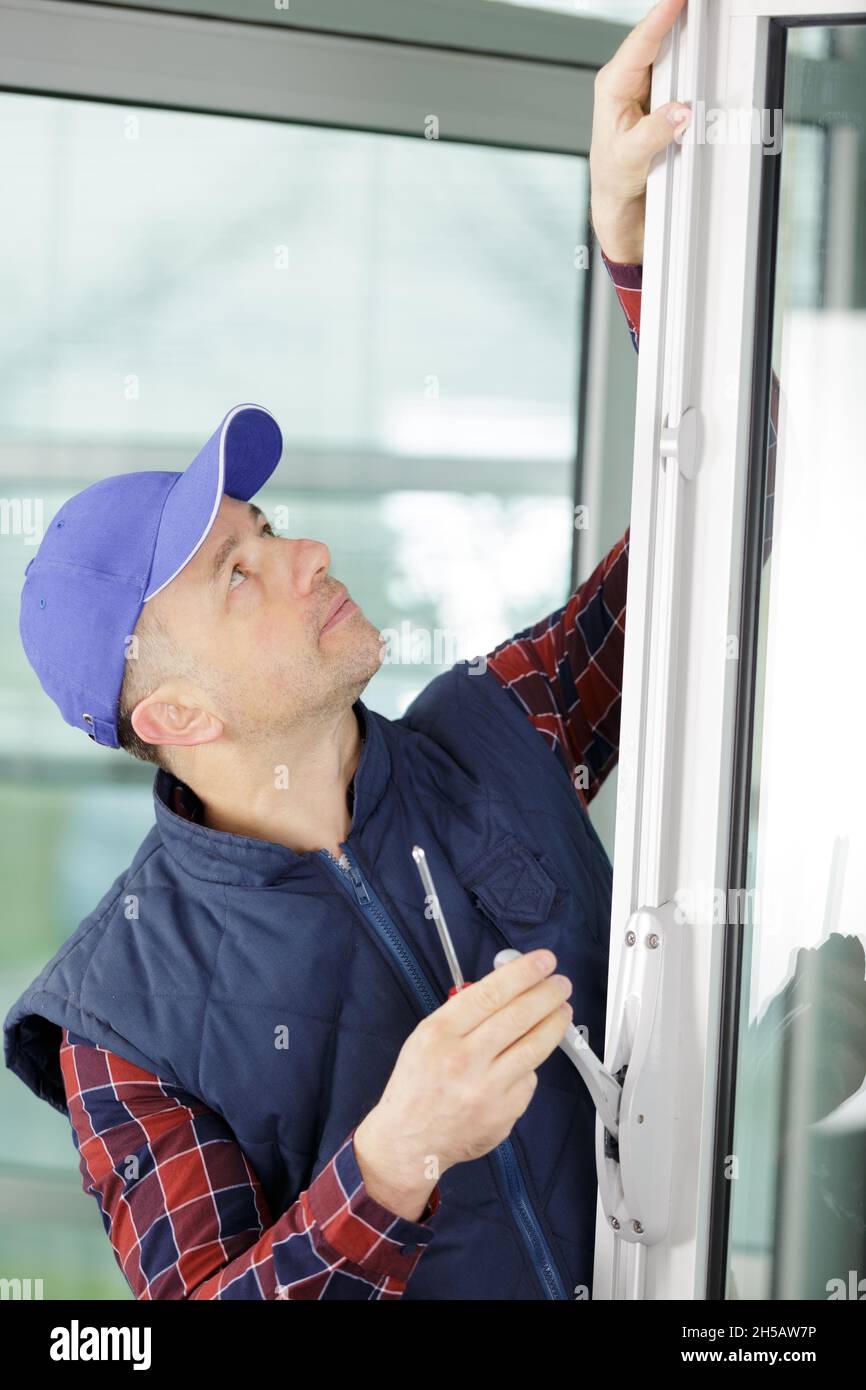 builder worker installing glass windows Stock Photo - Alamy