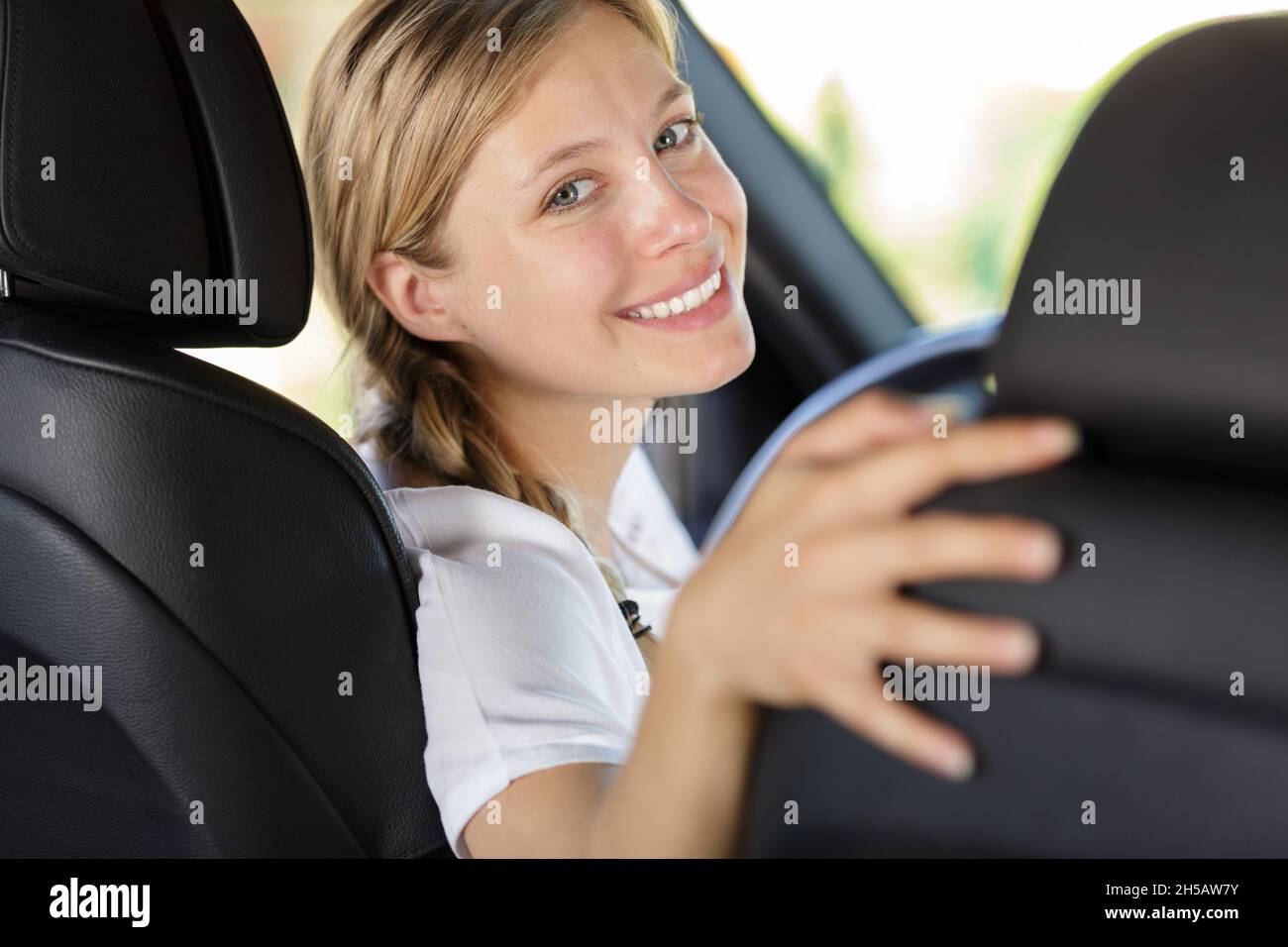 female driver looks behind going reverse Stock Photo - Alamy