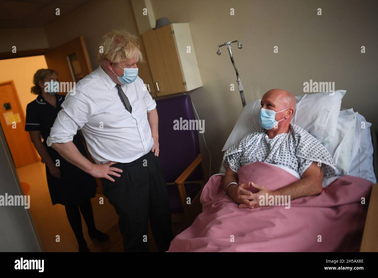 Prime Minister Boris Johnson talks with patient Melvin Gun during a ...