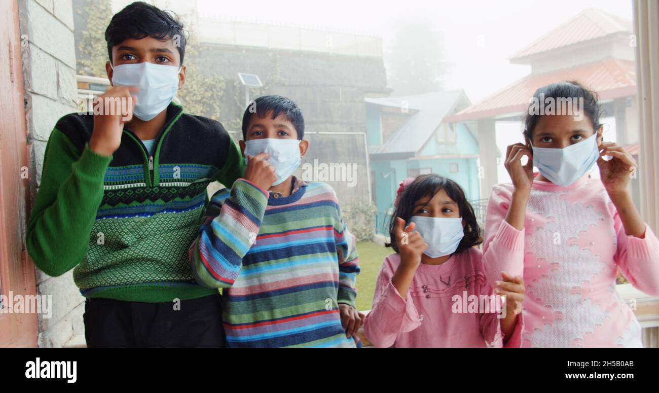 Children with masks playing at home Stock Photo - Alamy