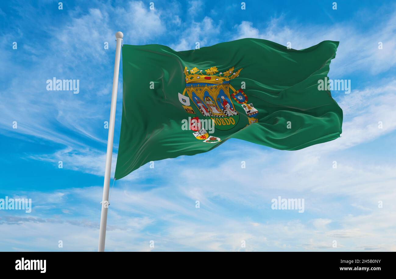 flag of Sevilla Spain , Spain at cloudy sky background on sunset ...