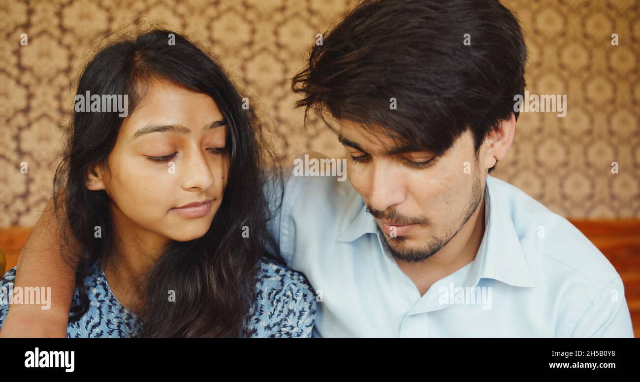 Indian couple sitting and speaking at home Stock Photo - Alamy