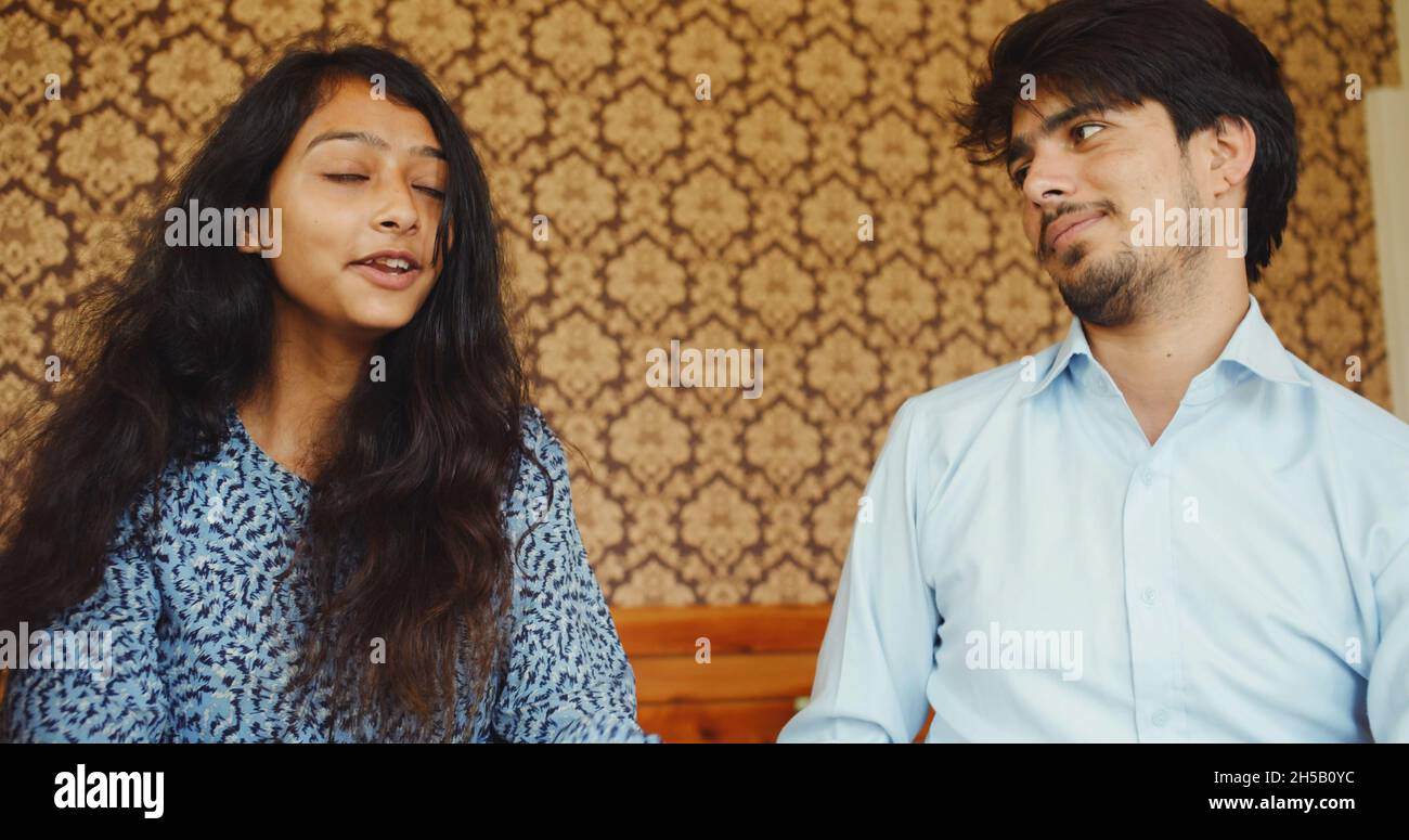 Indian couple sitting and speaking at home Stock Photo - Alamy