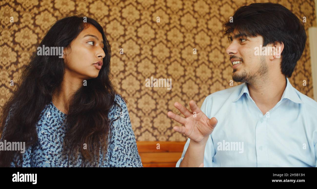 Portrait of young Indian man and a woman talking indoors Stock Photo ...
