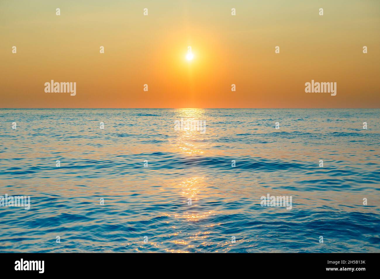 Mesmerizing view of a vibrant sunset at Lefkada, Greece with an orange ...