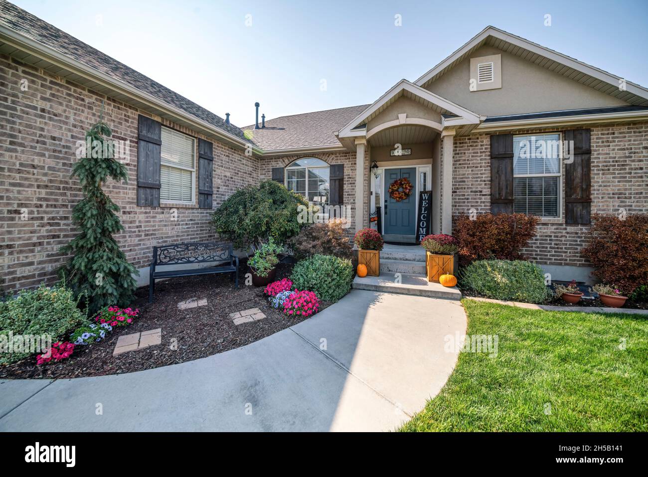 Facade of a house with bench in beautiful front yard garden Stock Photo ...