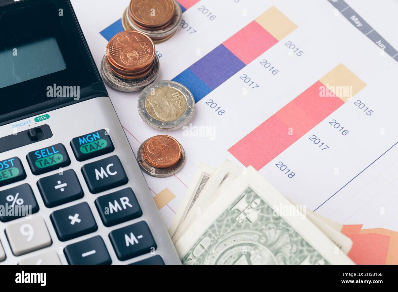 pile of money coins with graph paper on wood table, concept in account ...