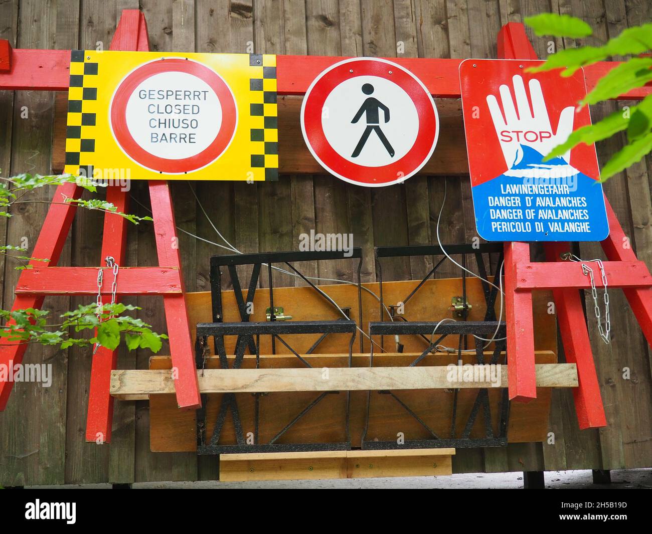 Metal signs "closed" in different languages, "stop danger" and no ...