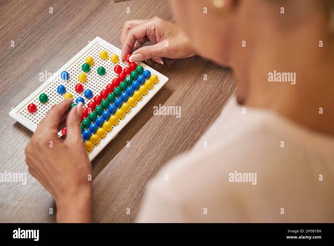 Female person during recovery of motor skills in rehabilitation center ...