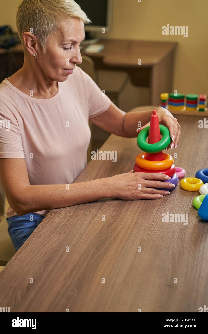 Mature woman while recovery of motor skills in clinic Stock Photo - Alamy