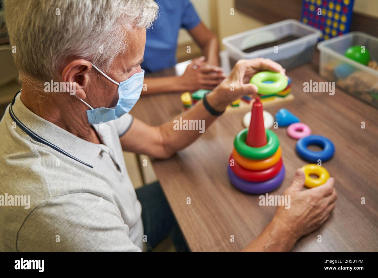 Mature man while recovery of motor skills in rehabilitation center ...