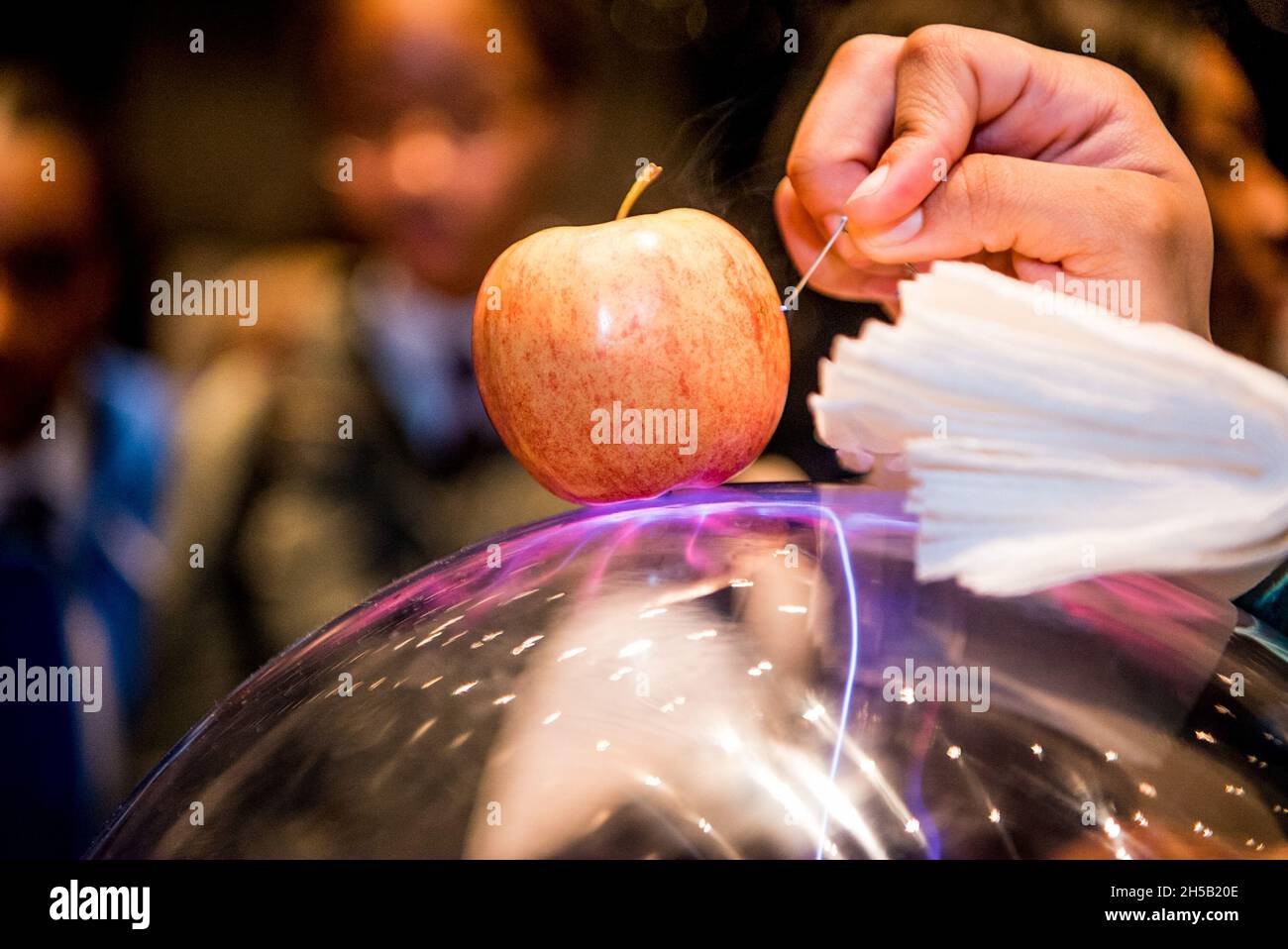 Science experiment using electricity to carve into an apple. Close up ...