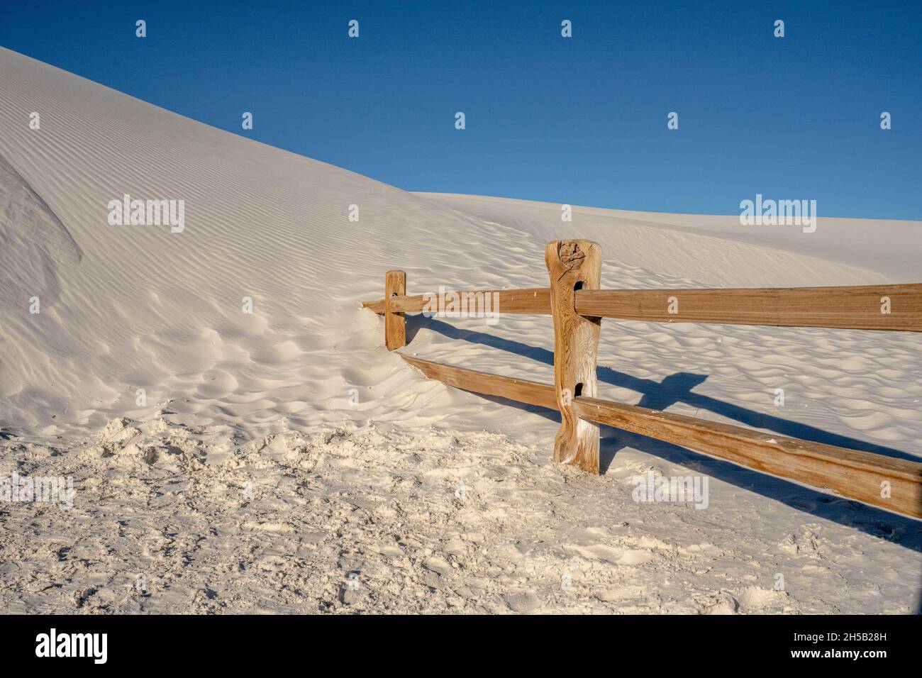 Sand Dunes Pile Over Wooden Fence in White Sands National Park Stock ...