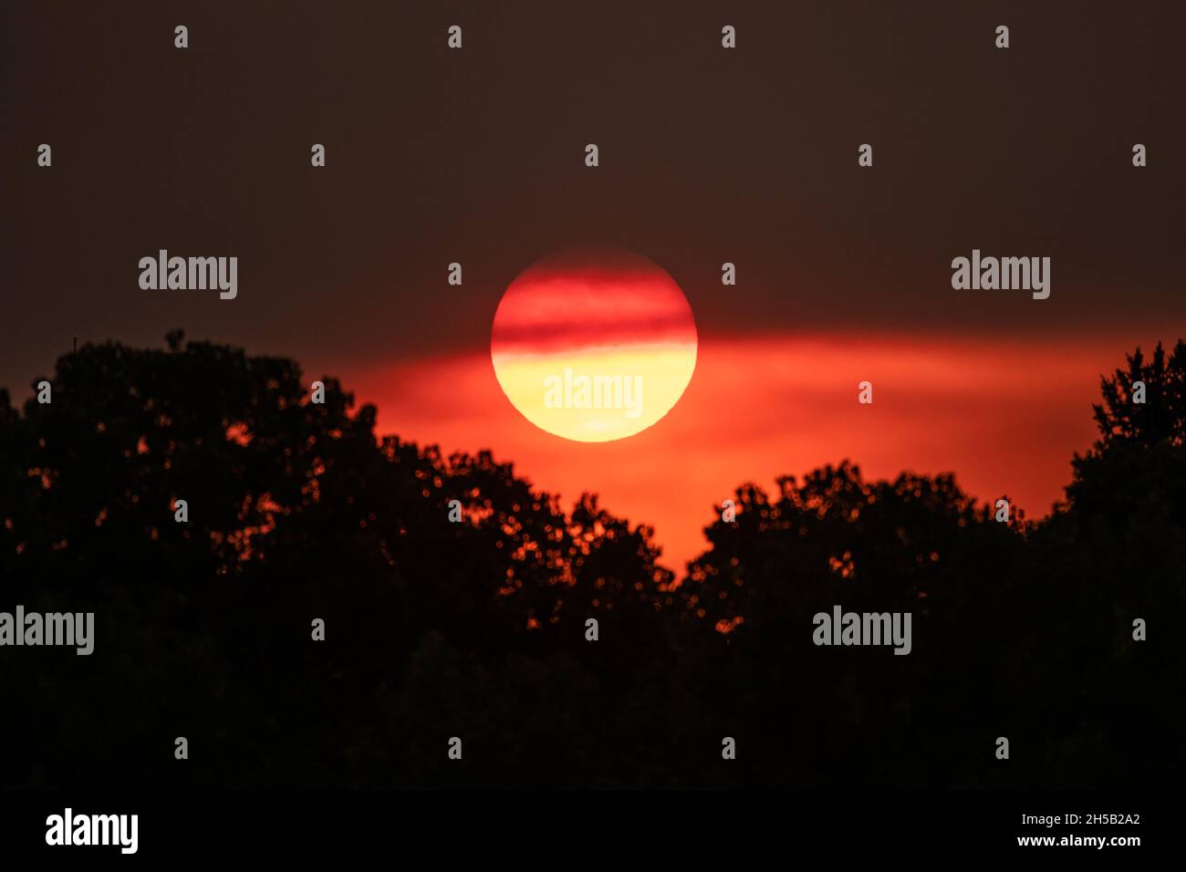 Sun Setting Through Forest Fire Smoke in Colorado sky Stock Photo - Alamy