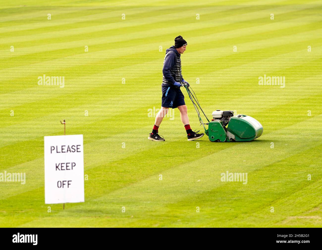A groundsperson tends to the pitch at Headingley Cricket Ground, Leeds ...