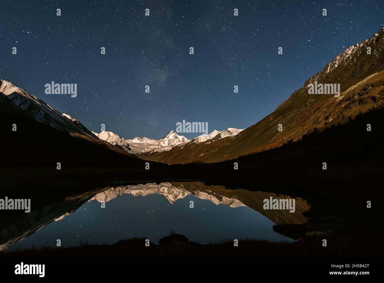Amazing night autumn landscape with a starry sky above a glacier and ...