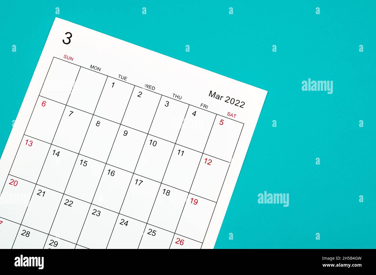 Close up March 2022 calendar sheet on bule background Stock Photo - Alamy
