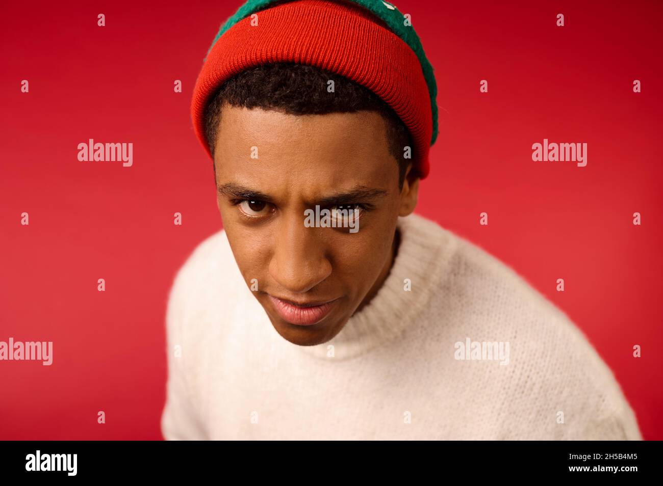 A close up picture of a young man in red hat Stock Photo - Alamy