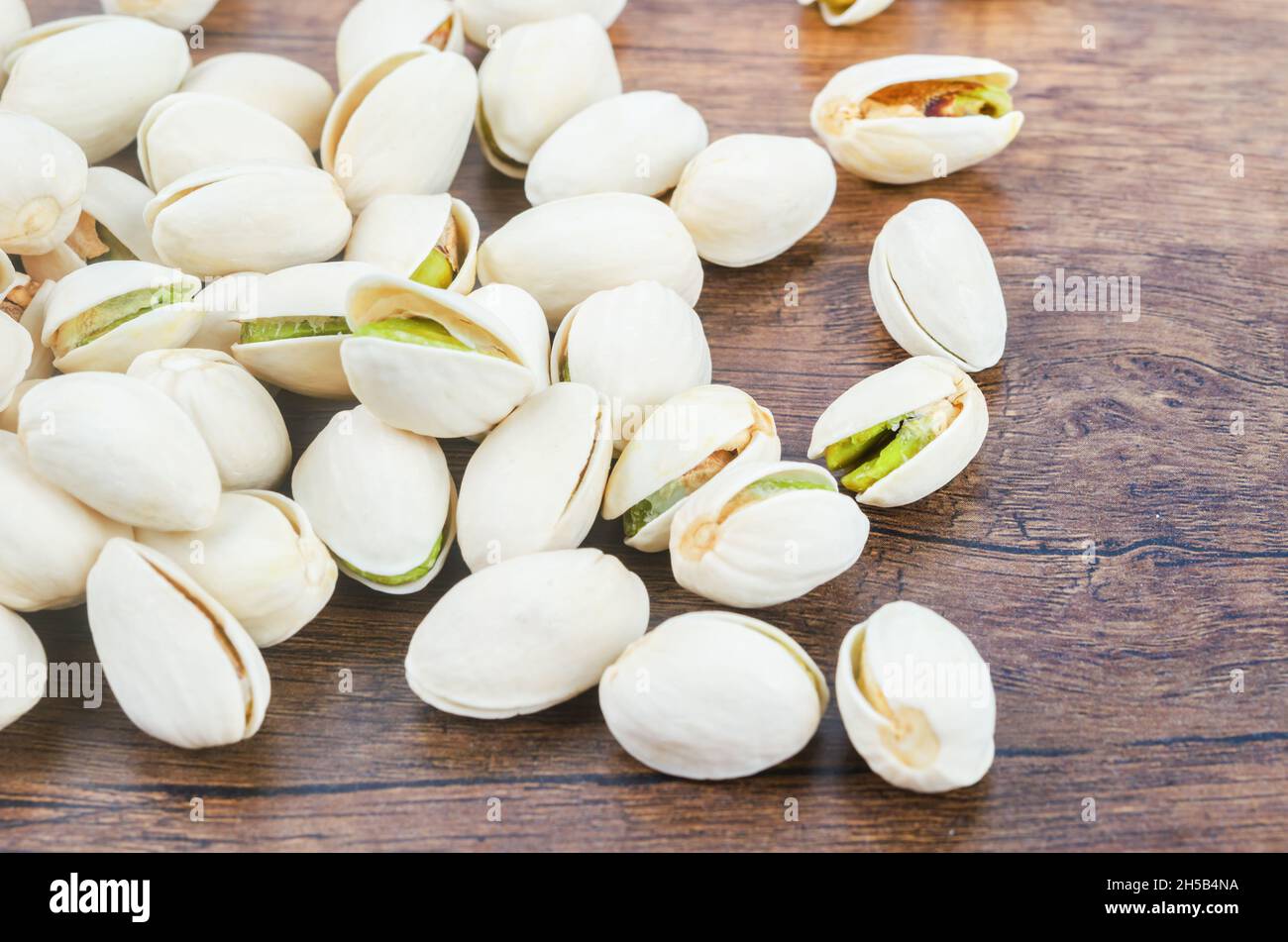 Pile pistachios on table in hi-res stock photography and images - Alamy