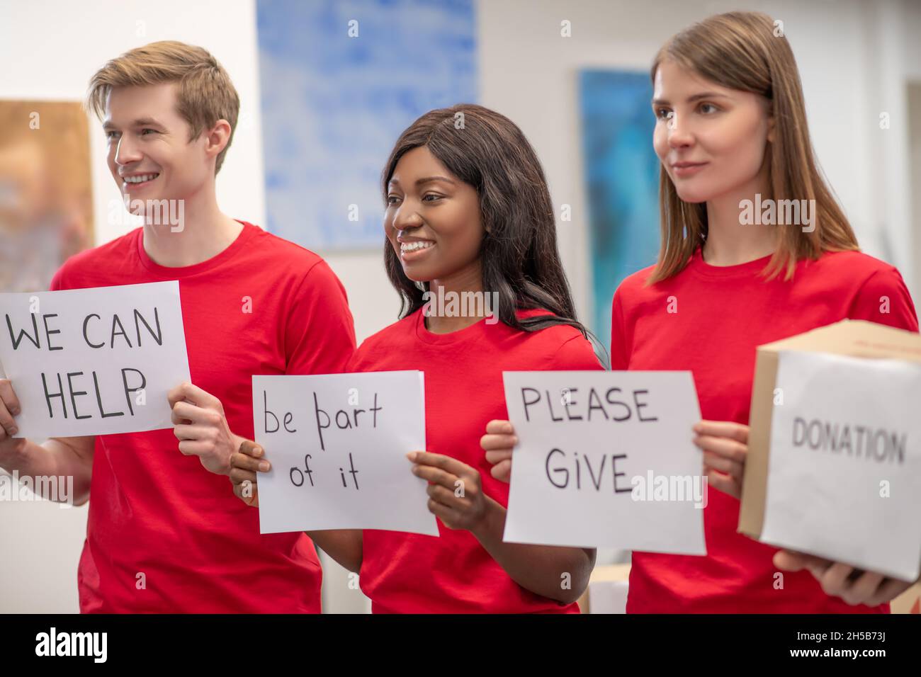 Young volunteers encouraging people to donate Stock Photo - Alamy