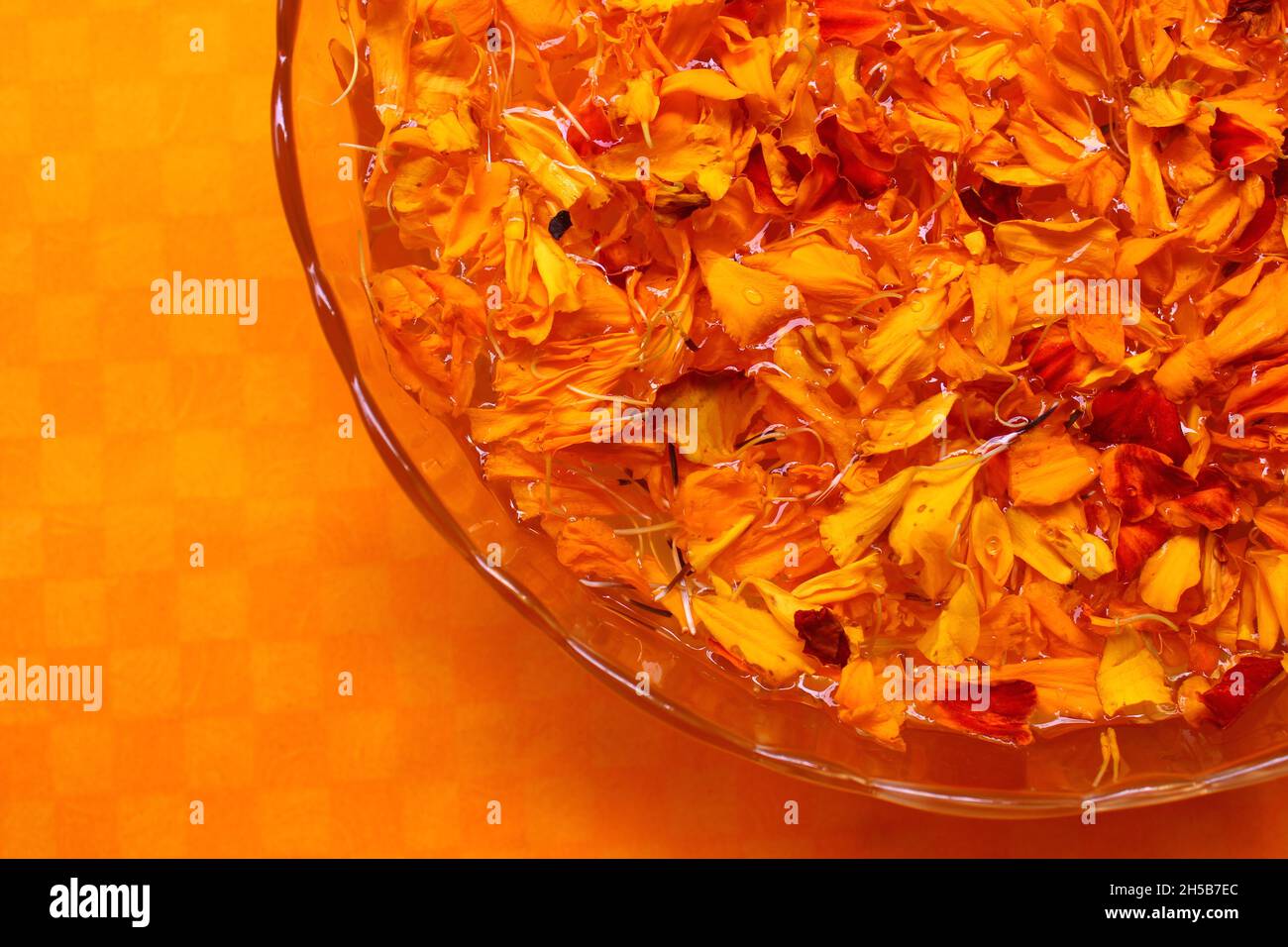 Closeup of Marigold flower petals in a transparent glass bowl filled ...