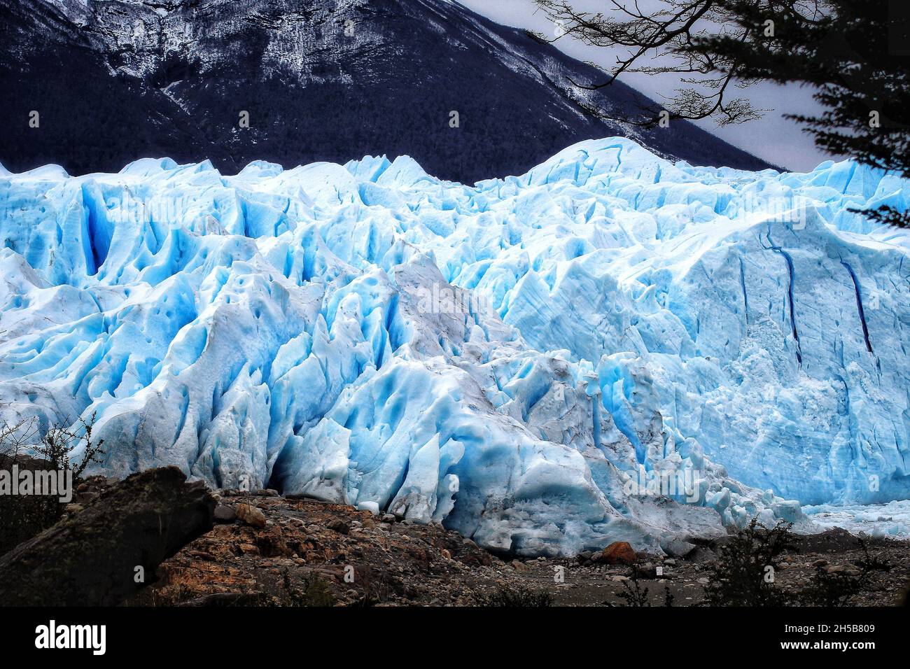 Eerie scenery of a glacier in the cold mountains Stock Photo - Alamy