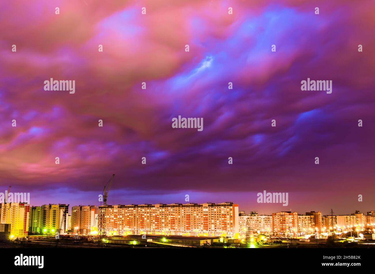 Violet sky clouds after a thunderstorm over the night city Stock Photo ...