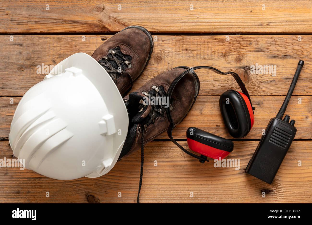 Work safety, labor personal protective gear on wooden background, top ...