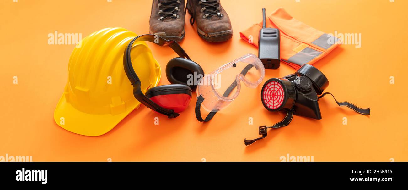 Work wear safety protection equipment on orange color background ...