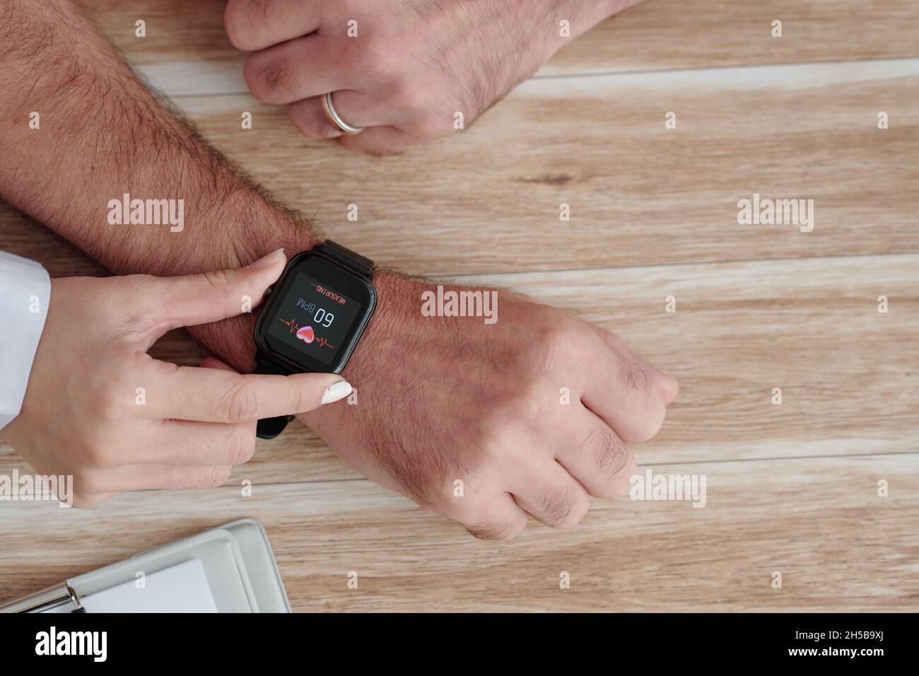 Hands of physician explaining senior patient how to use application on ...