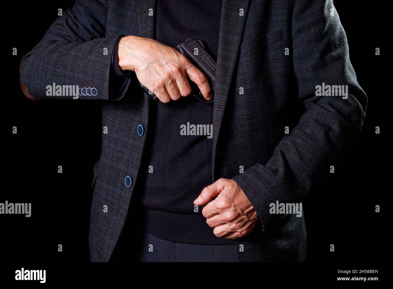 Pulling gun out of suit hi-res stock photography and images - Alamy